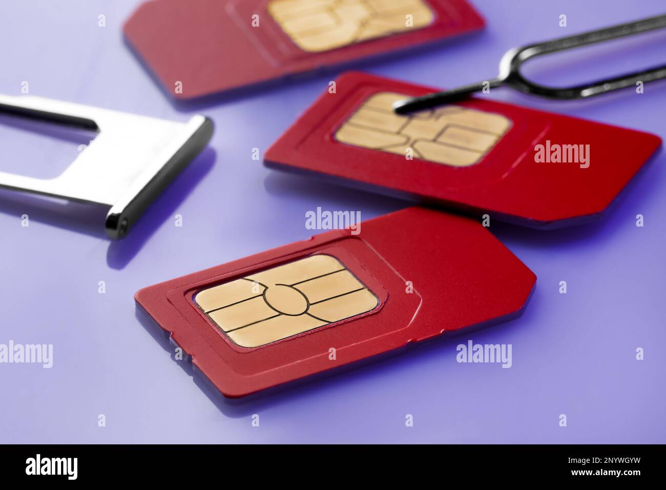 SIM cards, tray and ejector on violet background, closeup Stock Photo ...