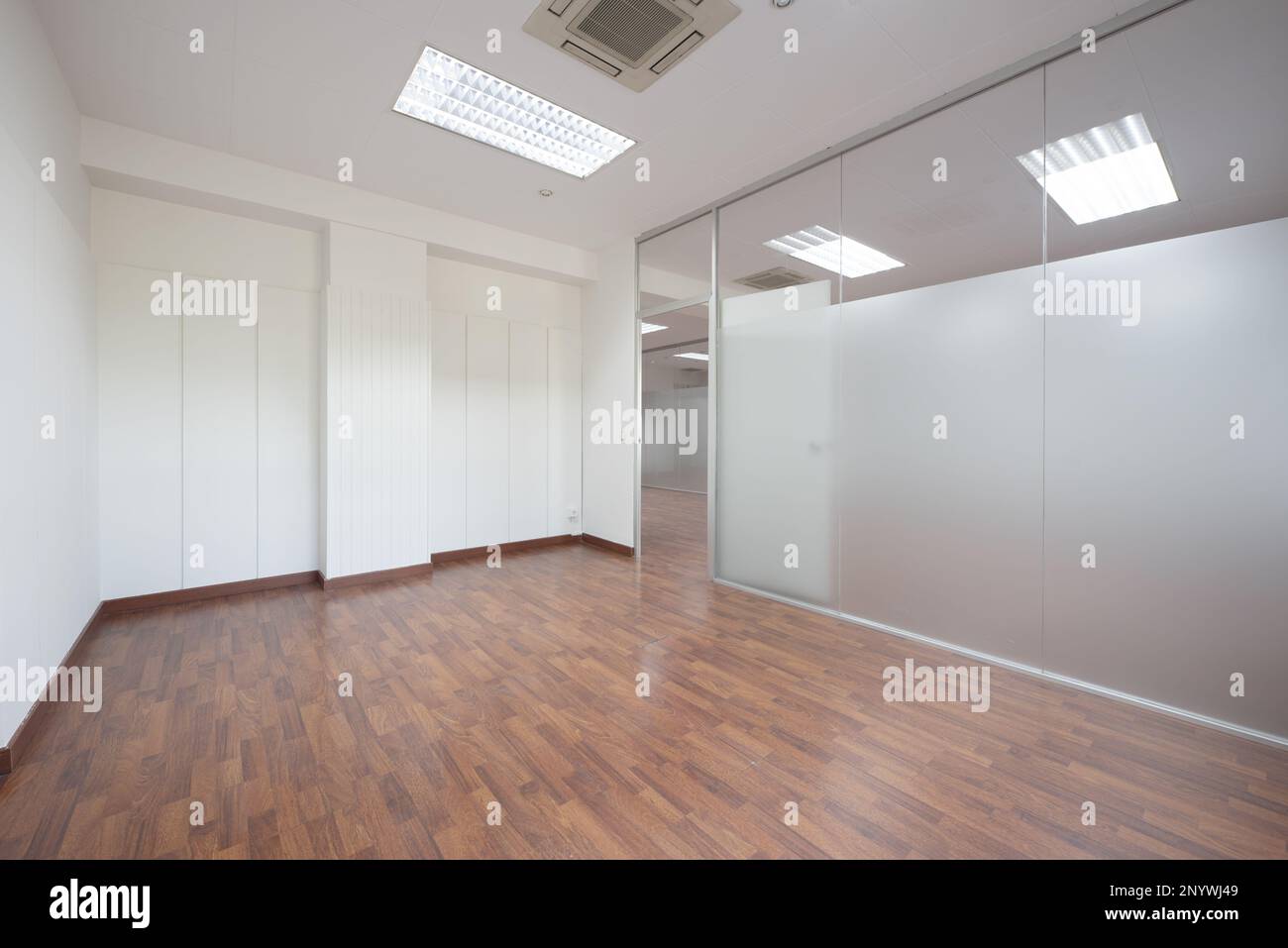 Empty office with technical ceilings, white walls with friezes and ...