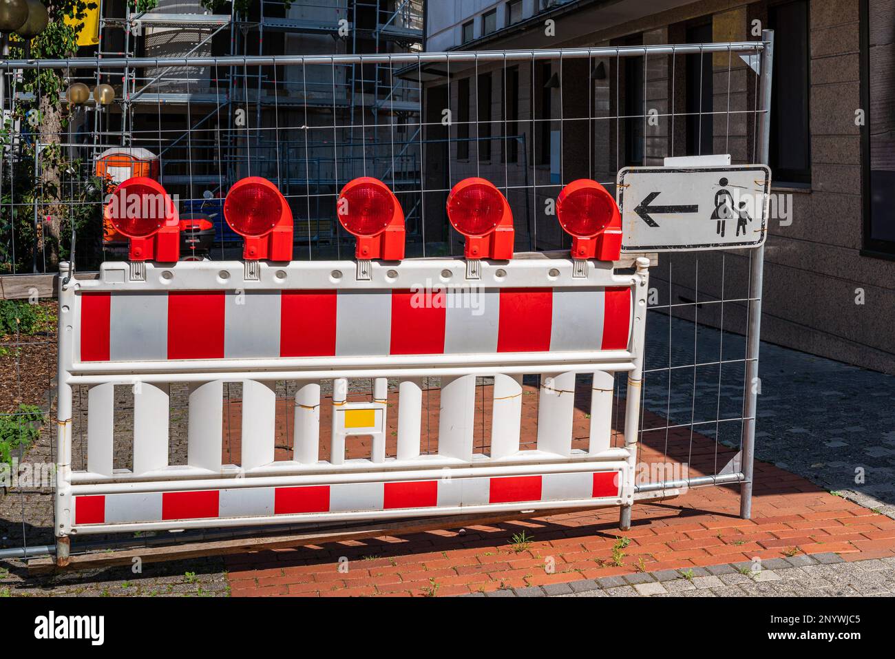 Red and white portable plastic barrier with red signal lights ...