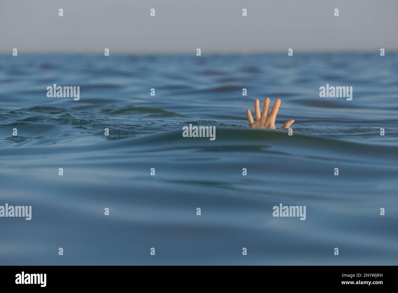 Drowning woman reaching for help in sea Stock Photo - Alamy