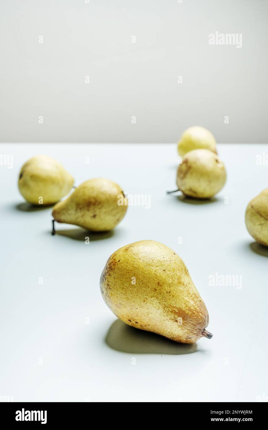 A few ripe pears on surface of a smooth subtle blue color Stock Photo ...