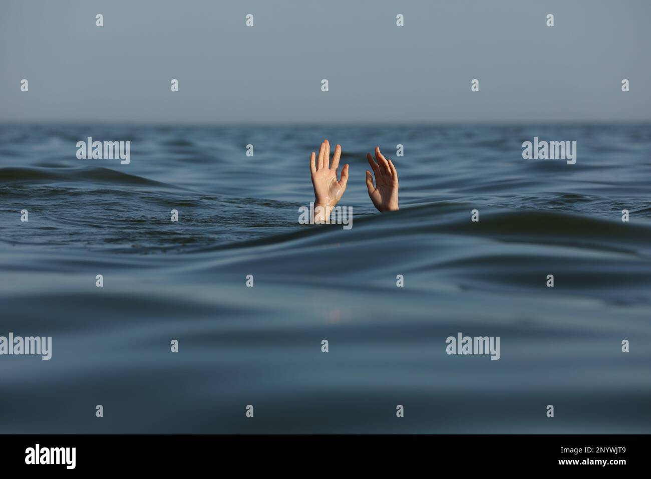 Drowning woman reaching for help in sea Stock Photo - Alamy