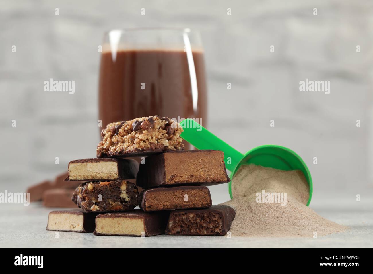 Different energy bars, protein cocktail and powder on grey table Stock ...