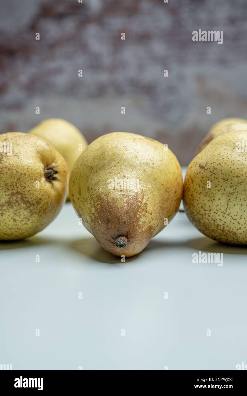 Some ripe pears on the surface of a subtle soft blue color and ...