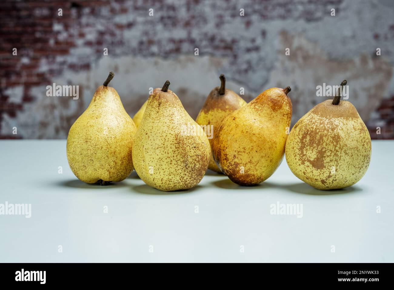 Some ripe pears on the surface of a subtle soft blue color and ...