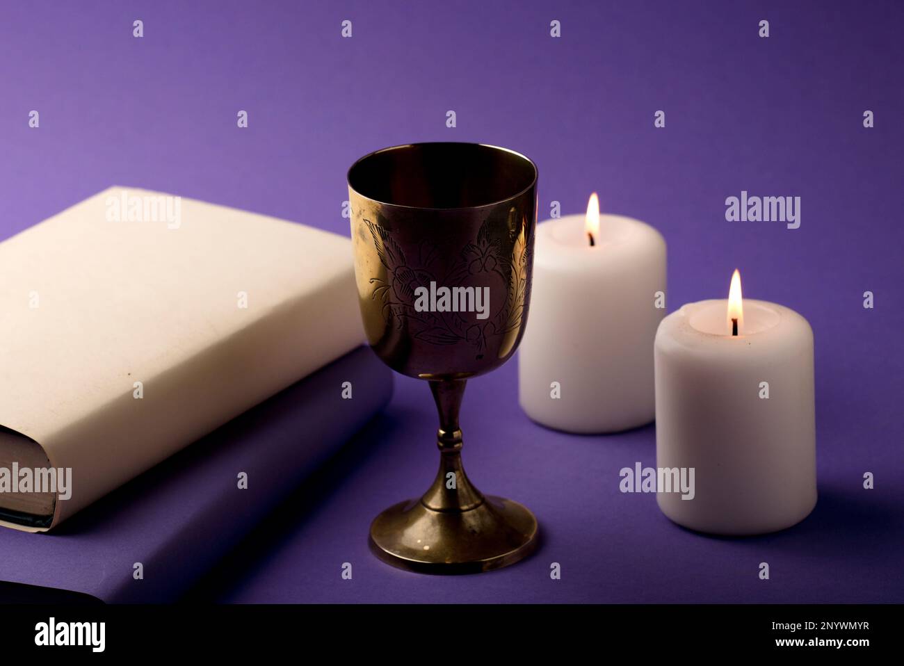 golden christian chalice with candles and purple background Stock Photo ...