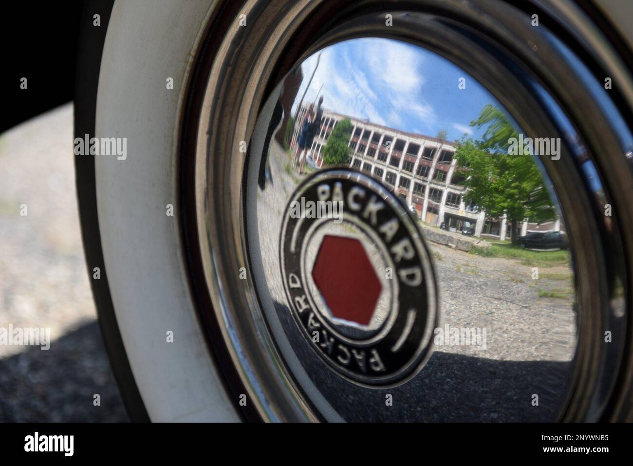 A reflection of the long-vacant Packard Plant can be seen on the tire ...