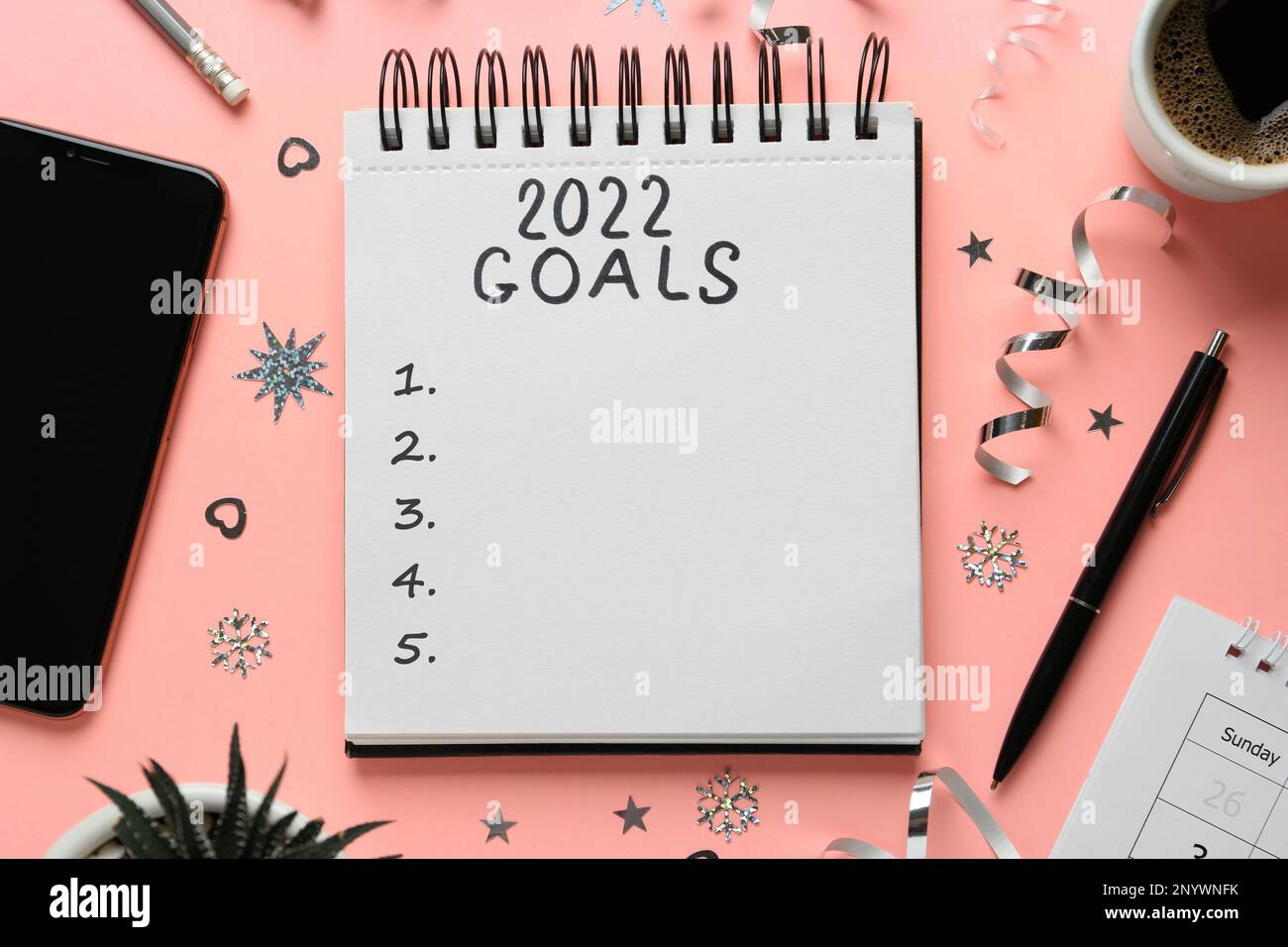 Inscription 2022 Goals written in notebook and different objects on ...
