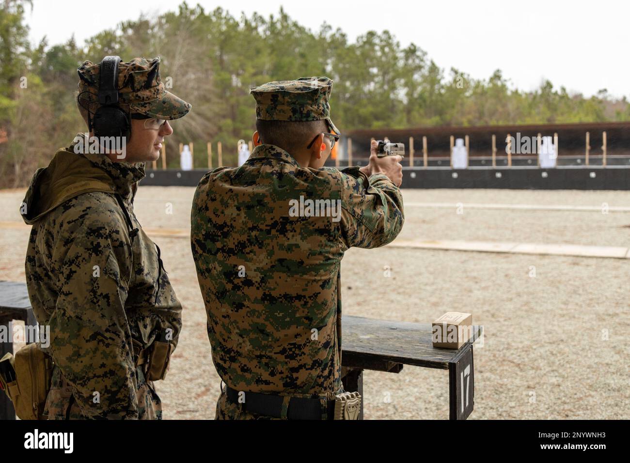 U.S. Marines with the School of Infantry-East, Combat Instructor School, coach each other while ...