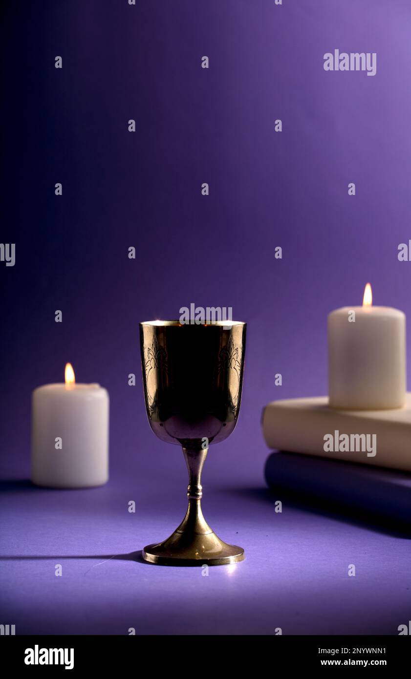 golden christian chalice with candles and purple background Stock Photo ...