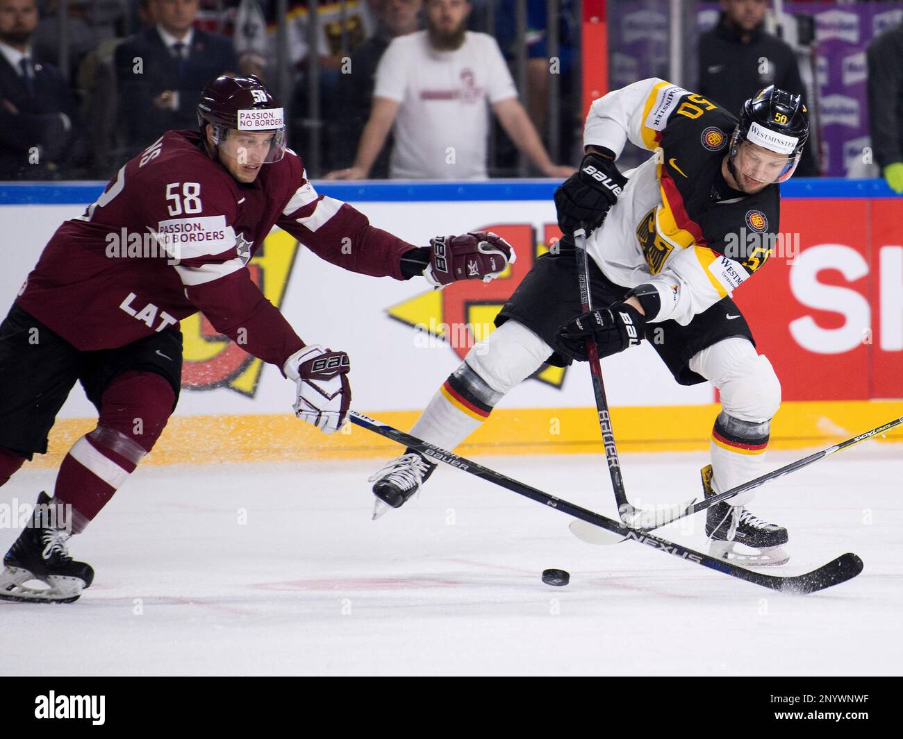 Germany's Patrick Hager, right, and Latvia's Guntis Galvins vie for the ...