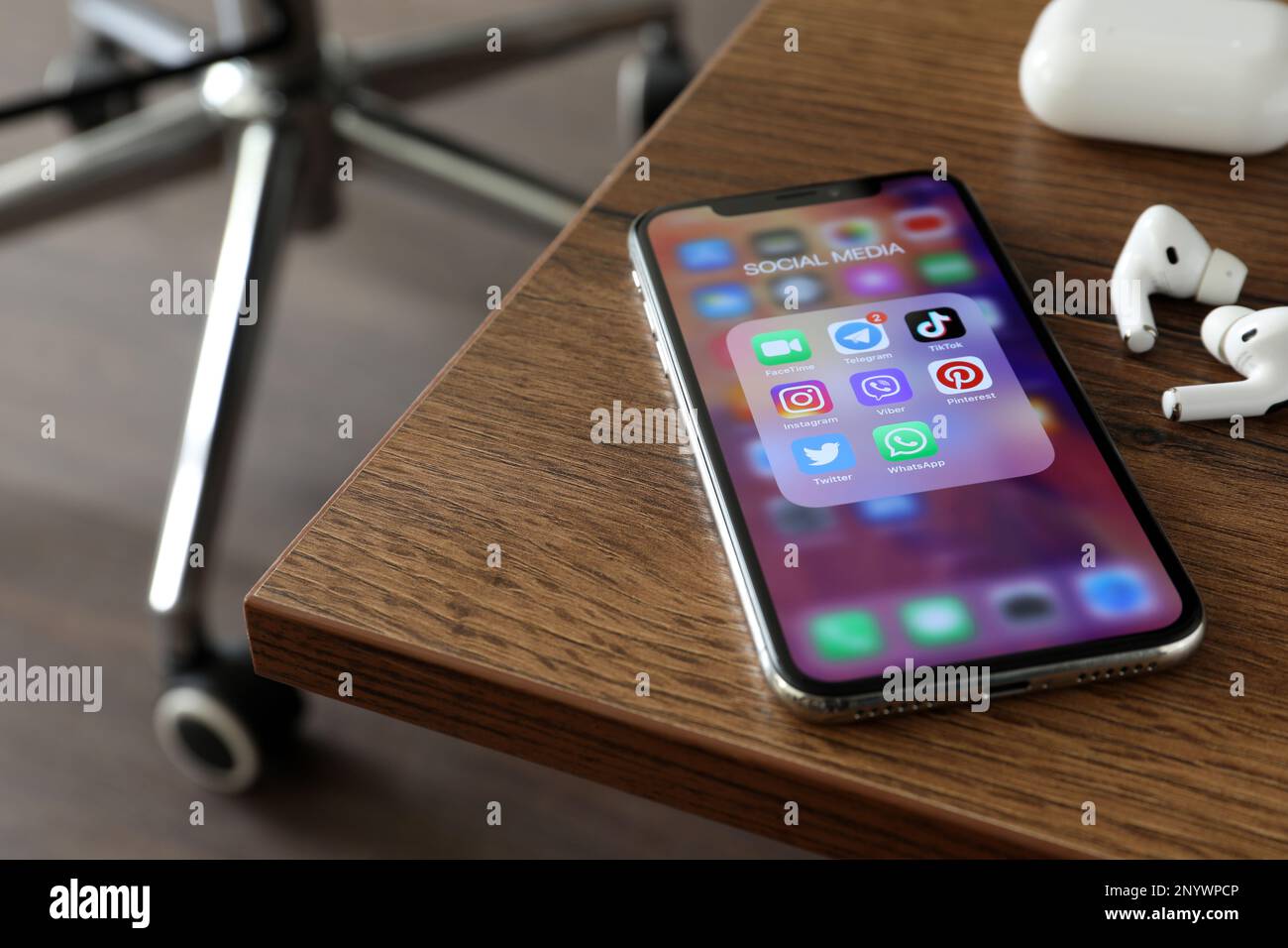 MYKOLAIV, UKRAINE - AUGUST 10, 2021: Apple iPhone X and AirPods on ...