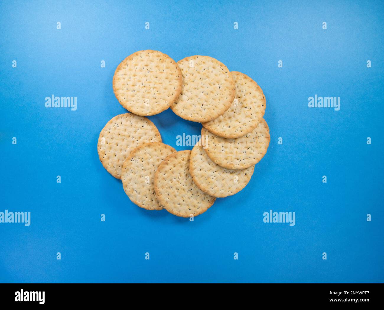open circle of round fresh biscuits isolated on a dark blue background ...