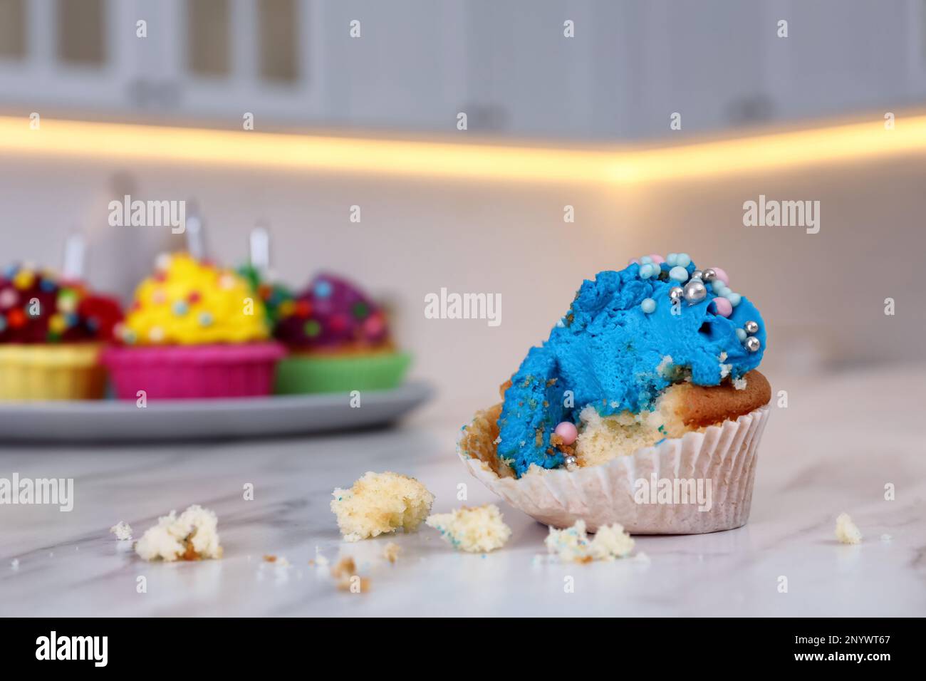 Failed cupcake with cream on light table in kitchen. Troubles happen ...