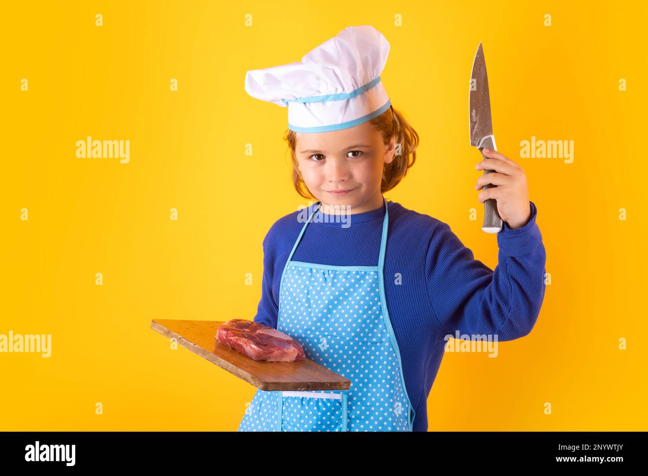 Kid cook hold cutting board with meat beef steak and knife. Chef kid ...
