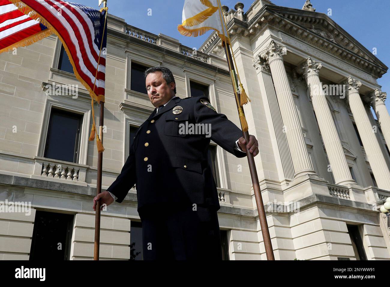 Sycamore Police Chaplain Tim Perry braces the American Flag with his ...