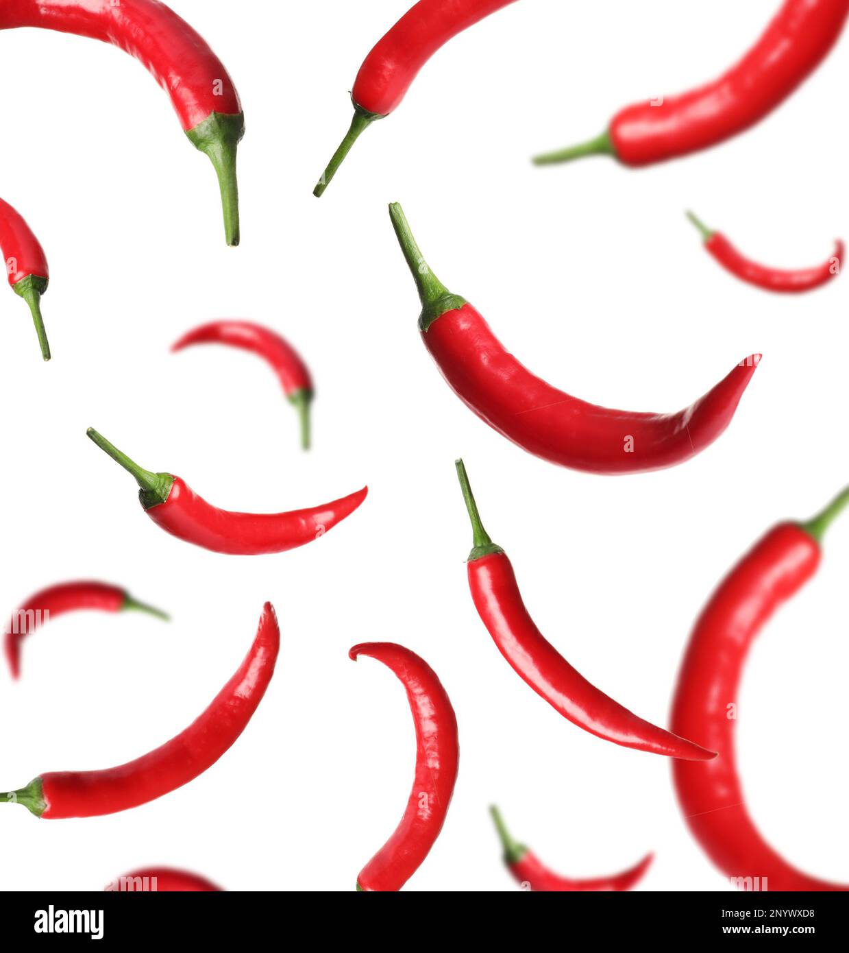 Ripe red chili peppers falling on white background Stock Photo - Alamy