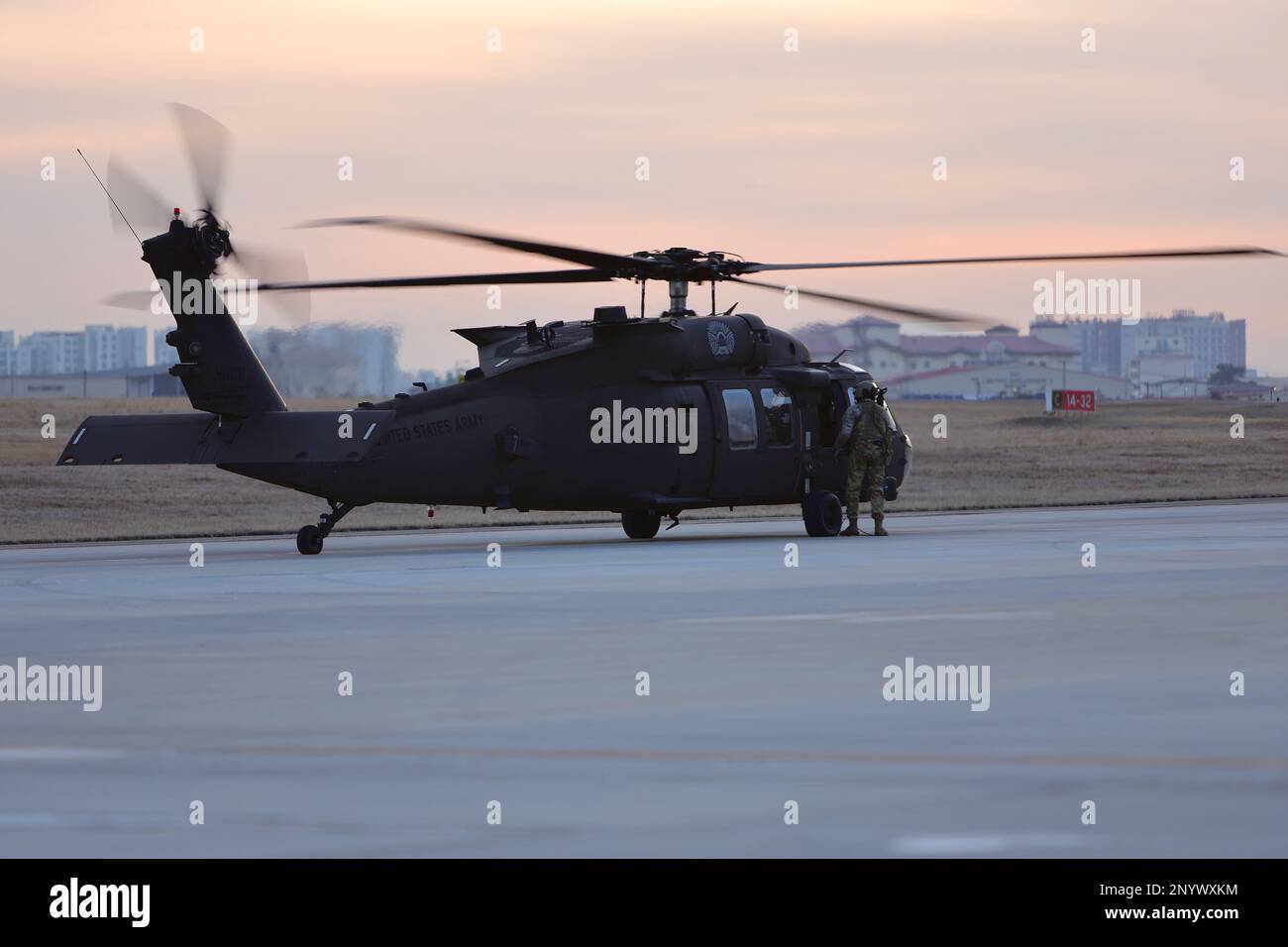 A UH-60M Blackhawk helicopter lines the runway at Desiderio Airfield ...