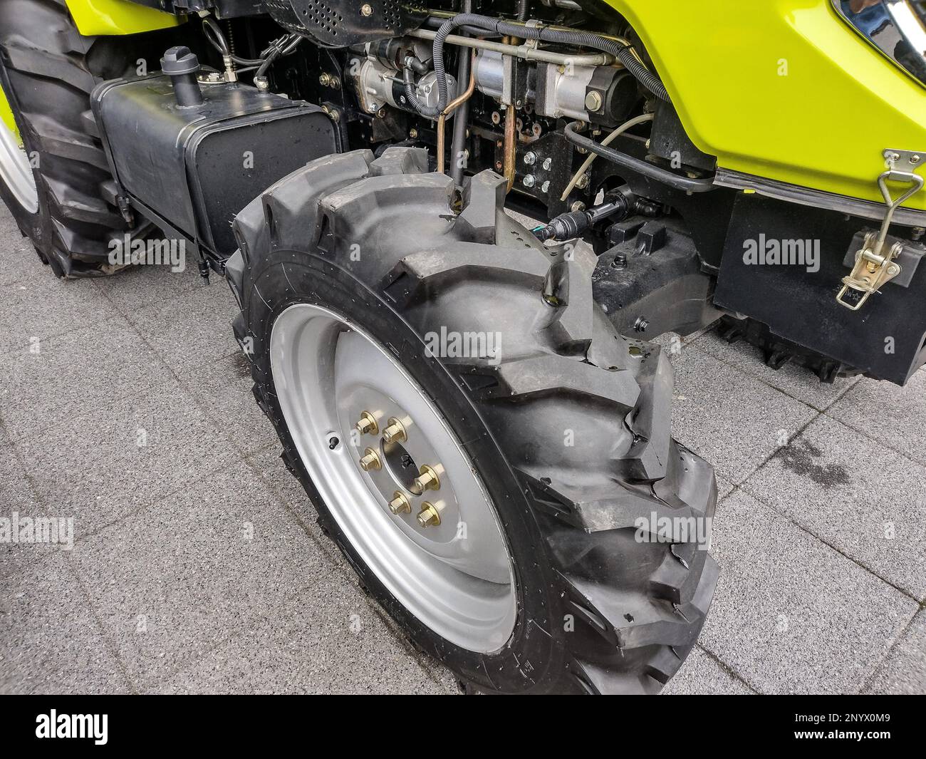 The wheels and the part where the engine of a tractor is located. New ...