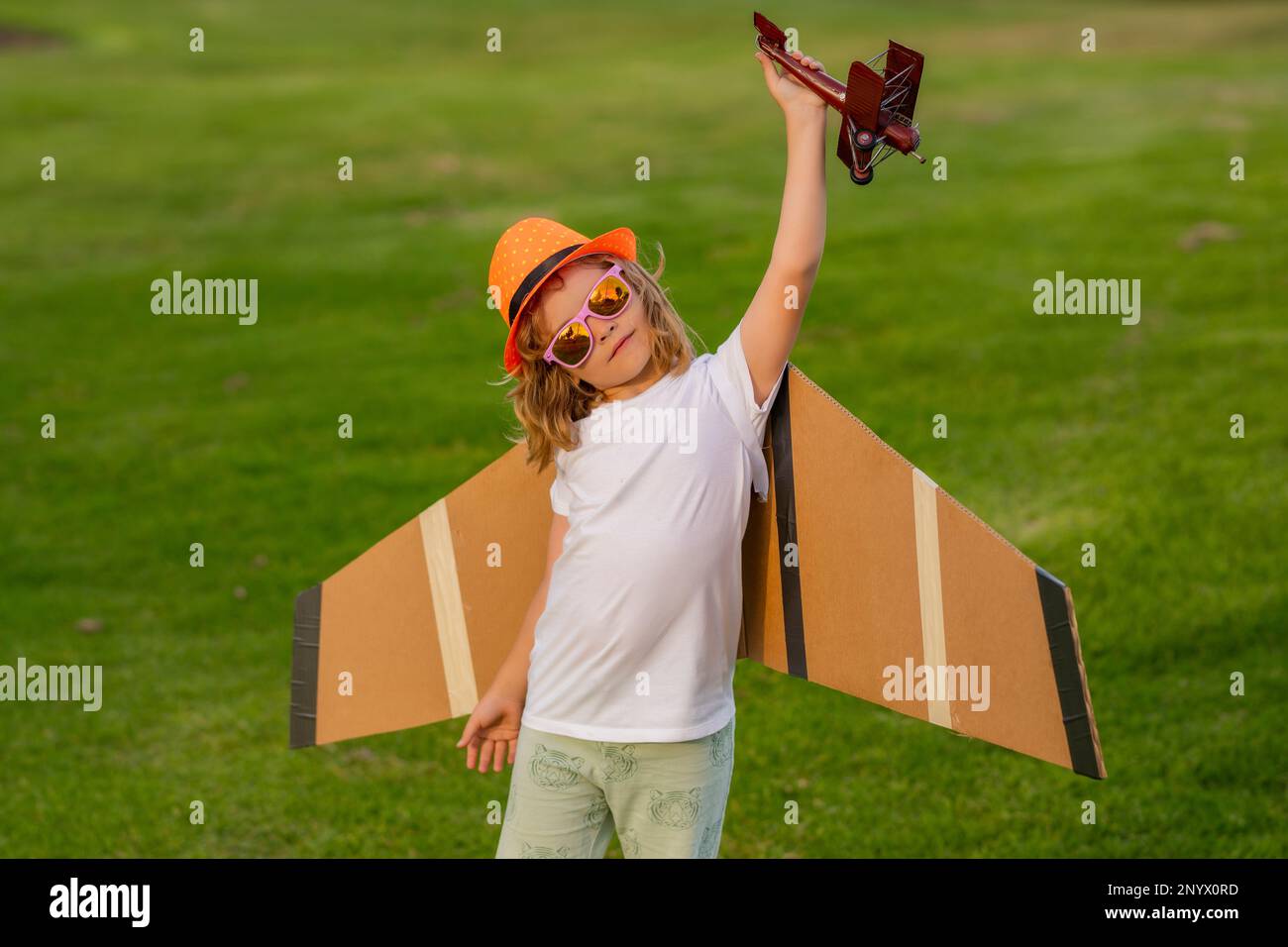 Boy kid dreams of becoming a pilot. Happy child playing outdoor. Kid ...