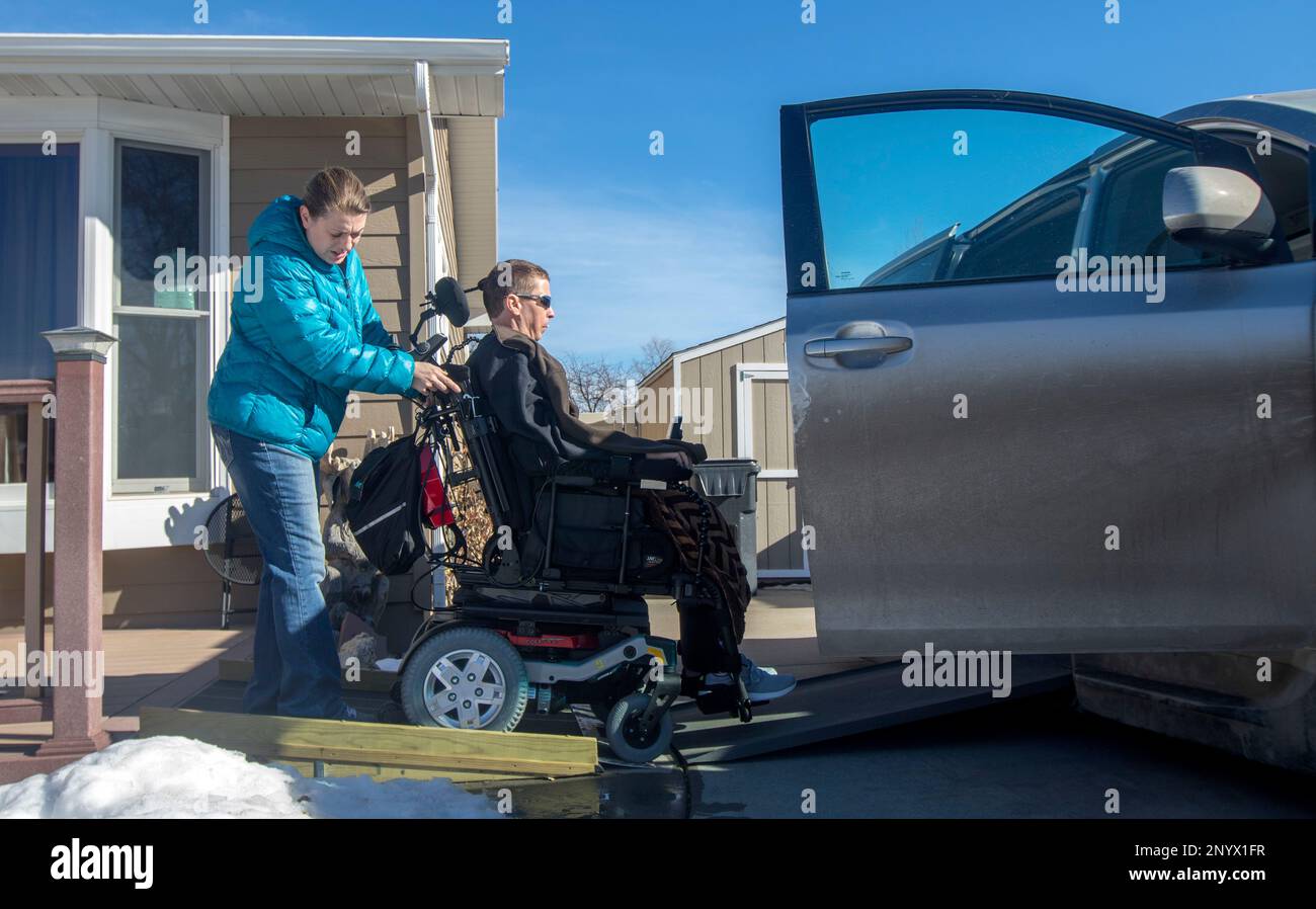 Josette helps guide Mark down the ramp from their front porch and into ...