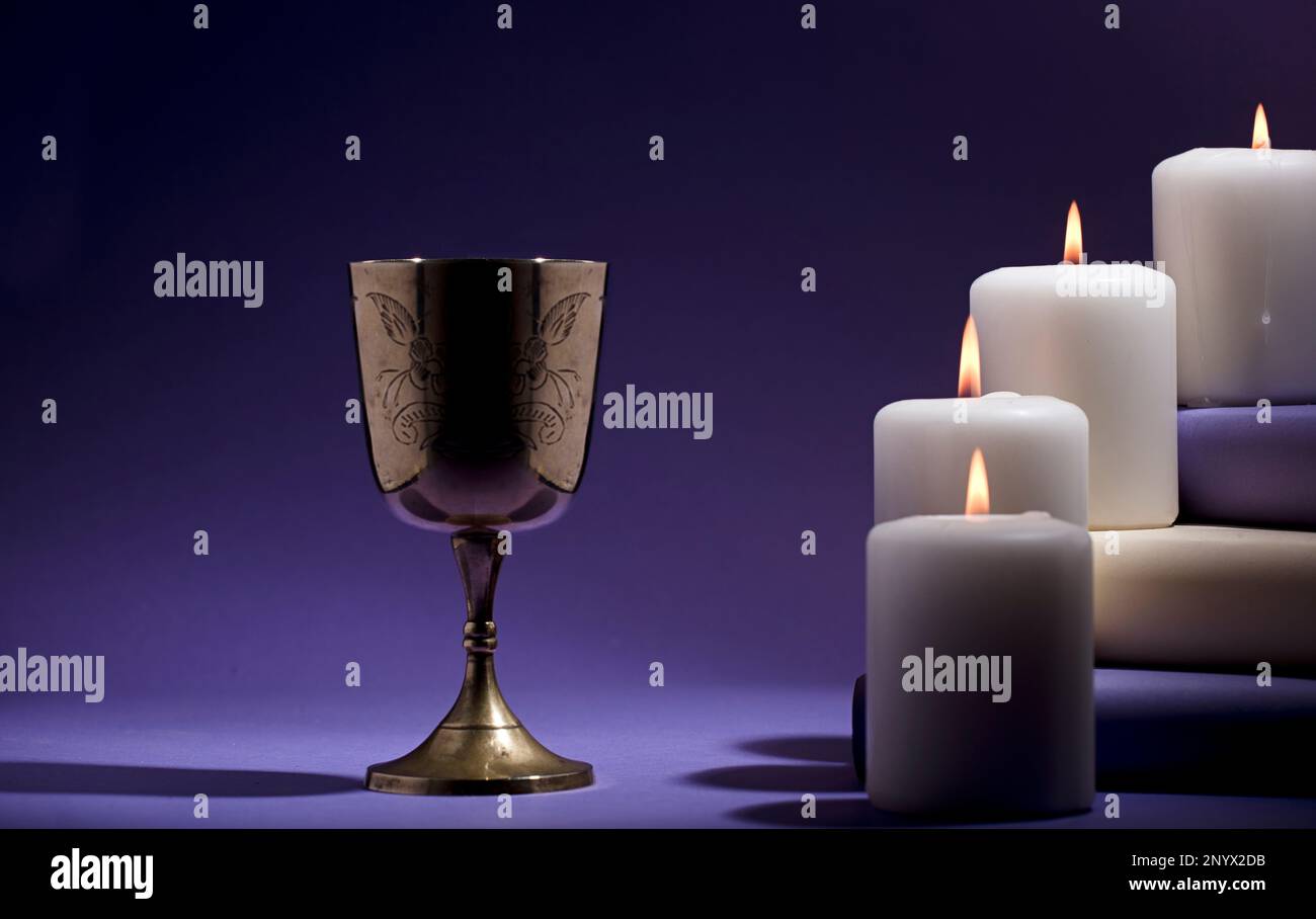 golden christian chalice with candles and purple background Stock Photo ...