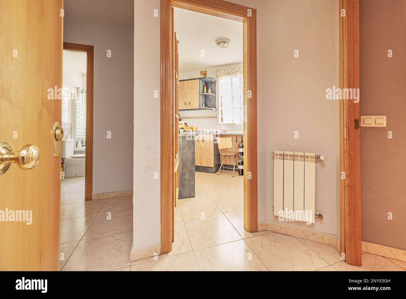 Entrance hall of a house with a light wooden access door with access ...