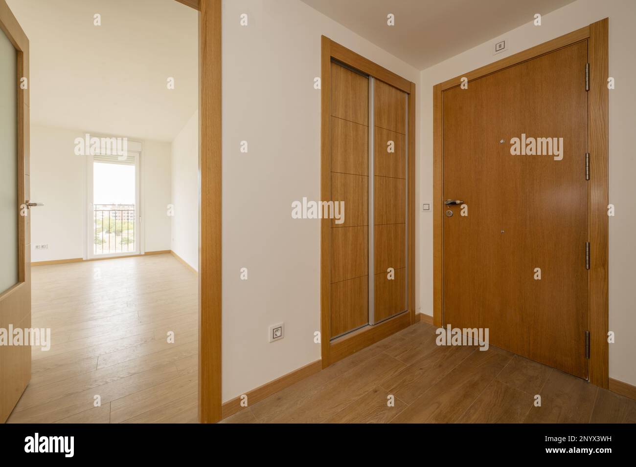 Entrance hall of an empty house with an oak access door to match the ...