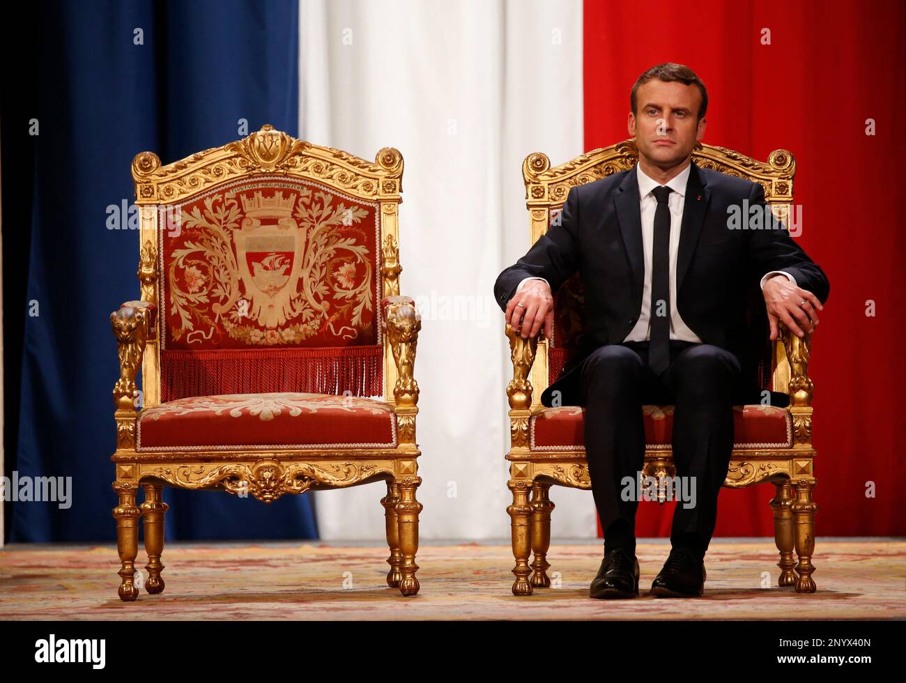 French President Emmanuel Macron listens as Paris Mayor Anne Hidalgo ...
