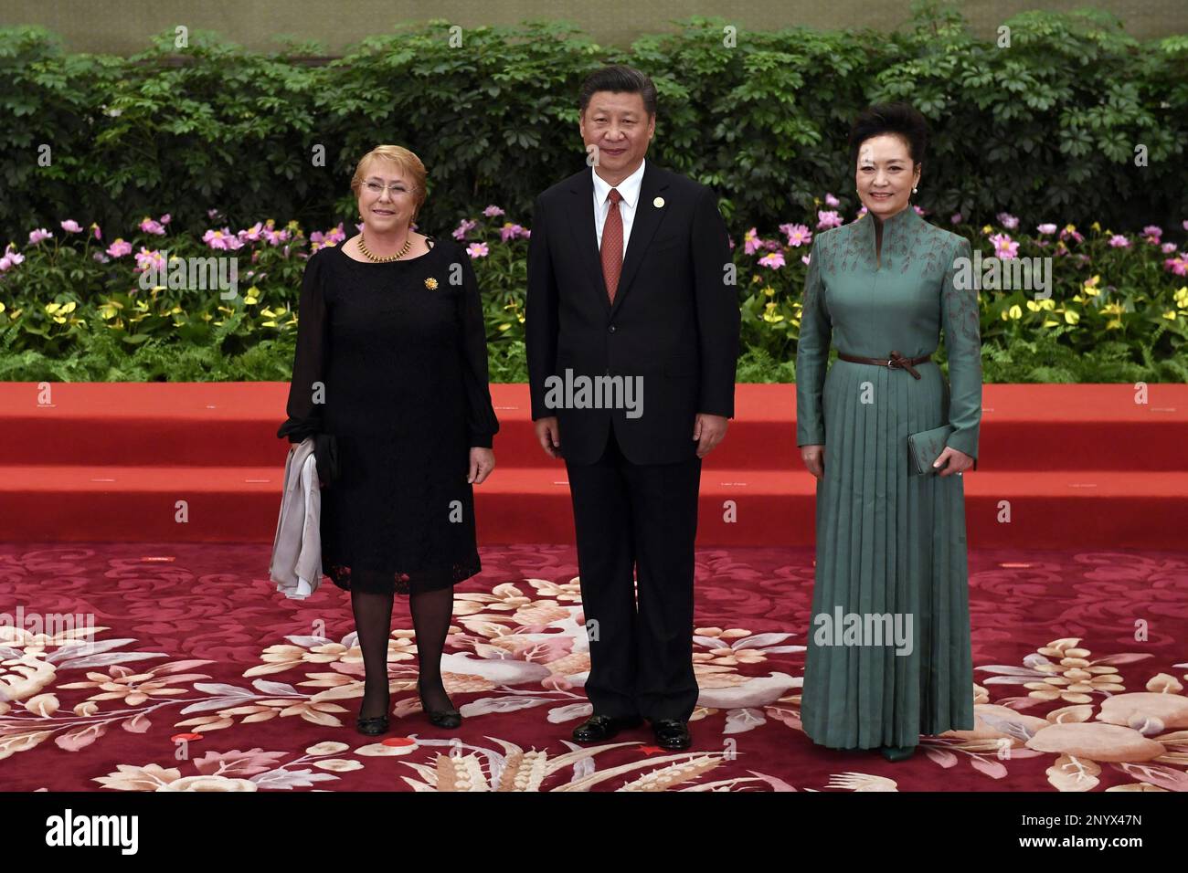 Chinese President Xi Jinping, center right, and his wife Peng Liyuan, pose for a photo with ...
