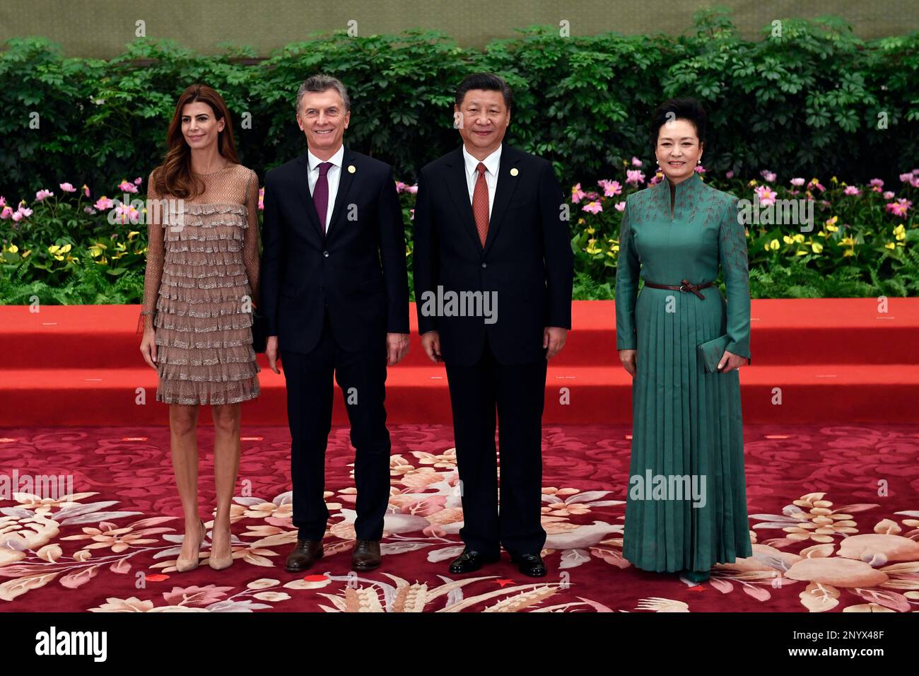 Chinese President Xi Jinping, center right, and his wife Peng Liyuan, pose for a photo with ...