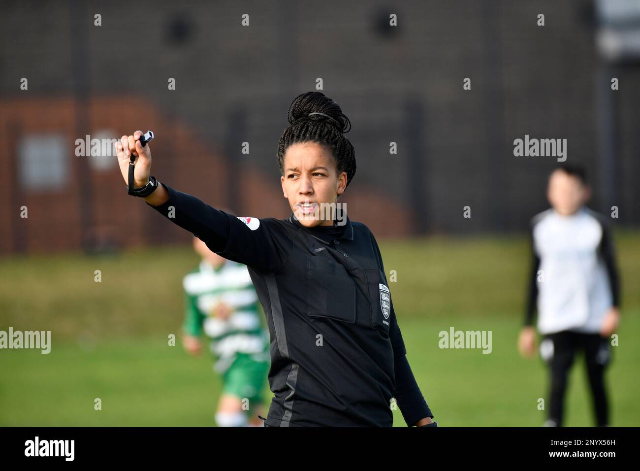 Young football referee in charge of junior football match Britain 2022 ...