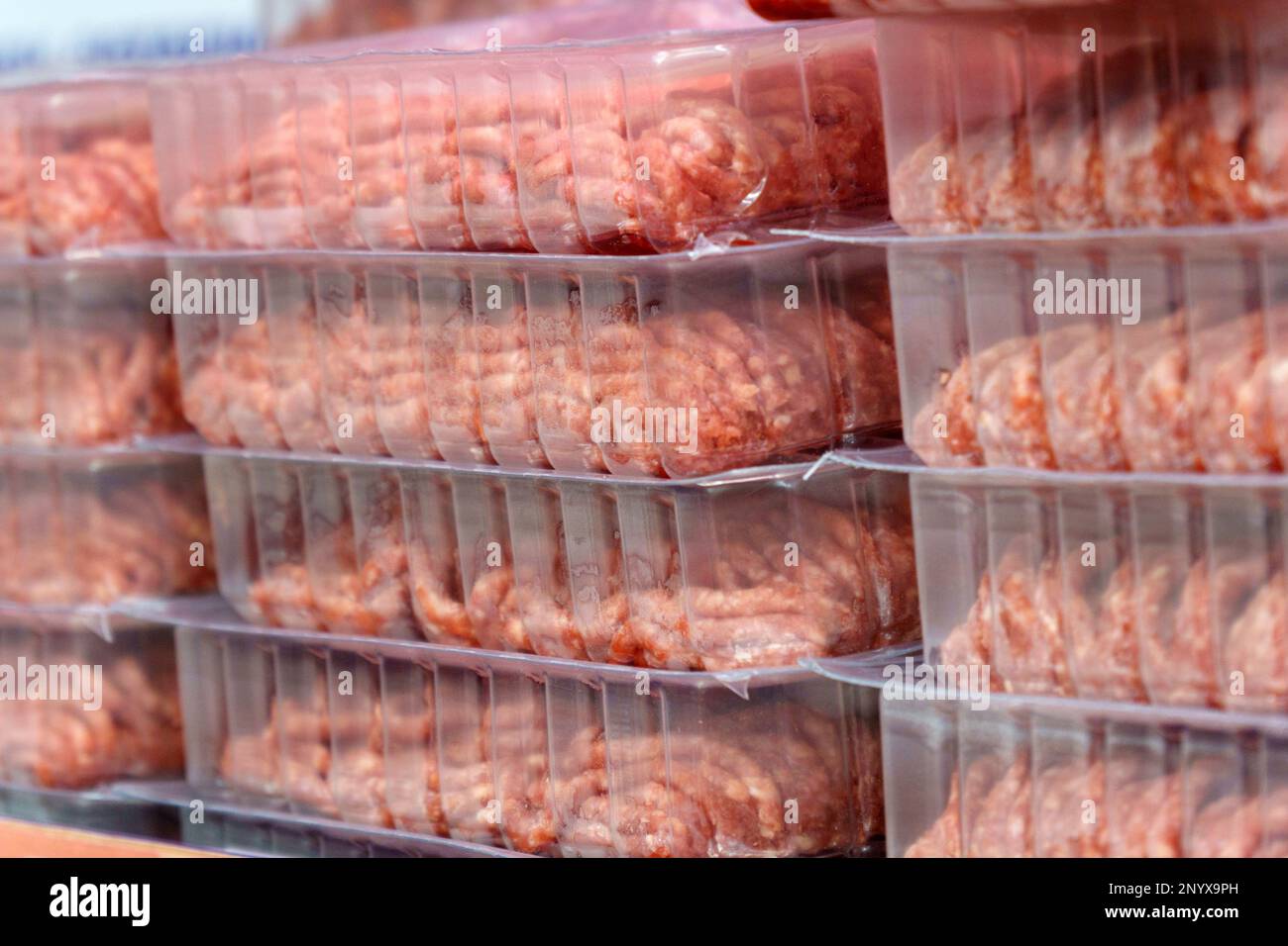 Raw minced meat in plastic packages in hypermarkets. Pink and white ...
