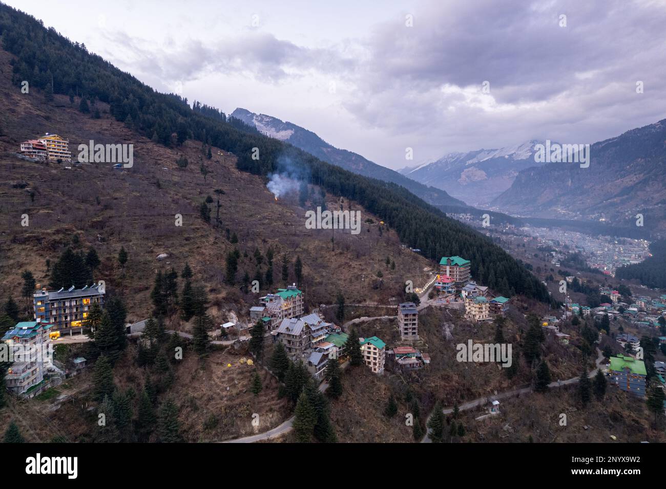 aerial drone landing shot showing lit multi floor story buildings on ...