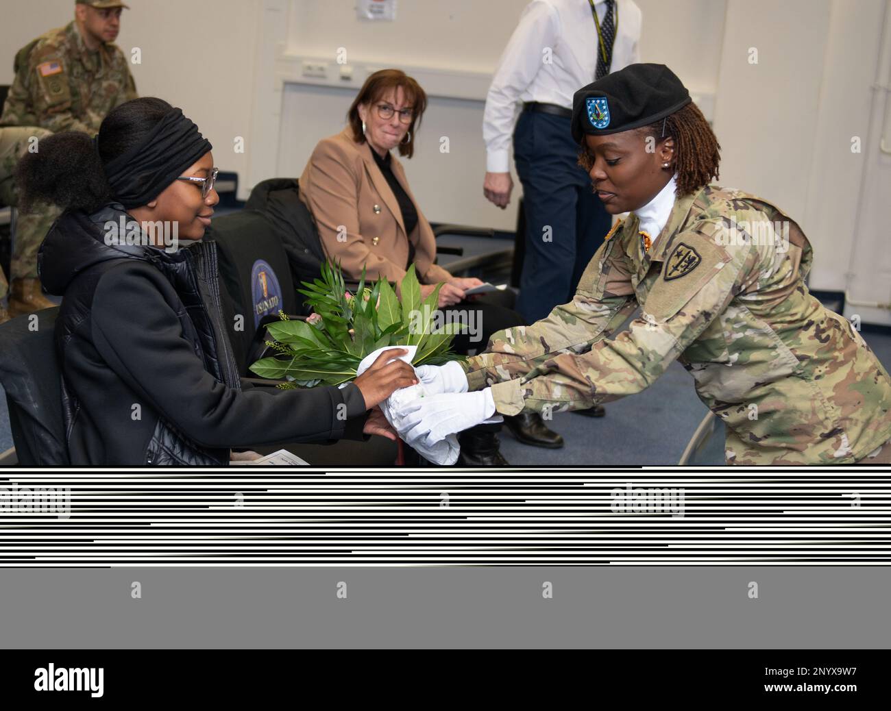 U.S. Army Staff Sgt. Daphne Pierre presents Command Sgt. Maj. Kisha M ...