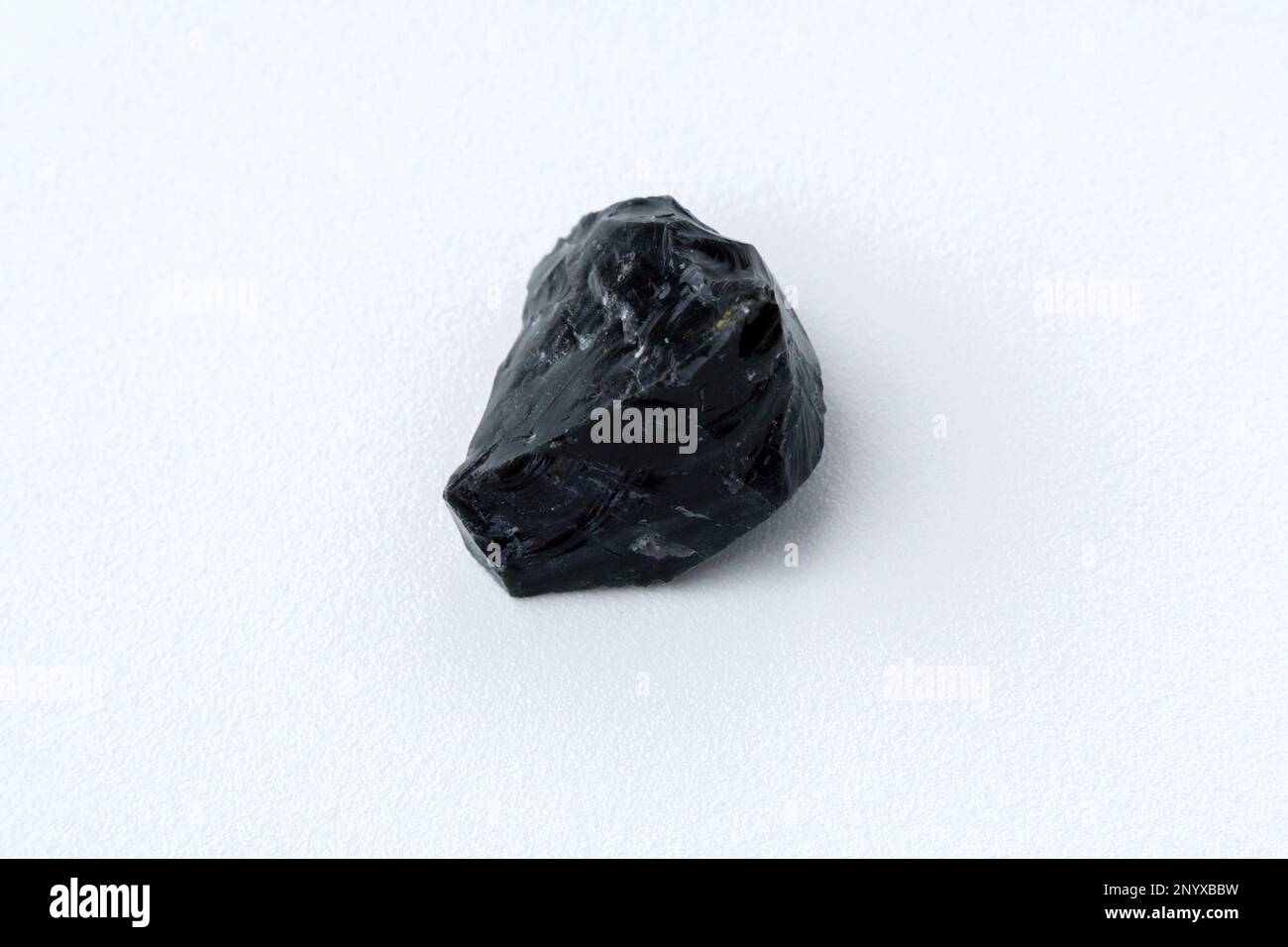 Obsidian rock. Volcanic material. Rough edges. Sharpest rock white ...
