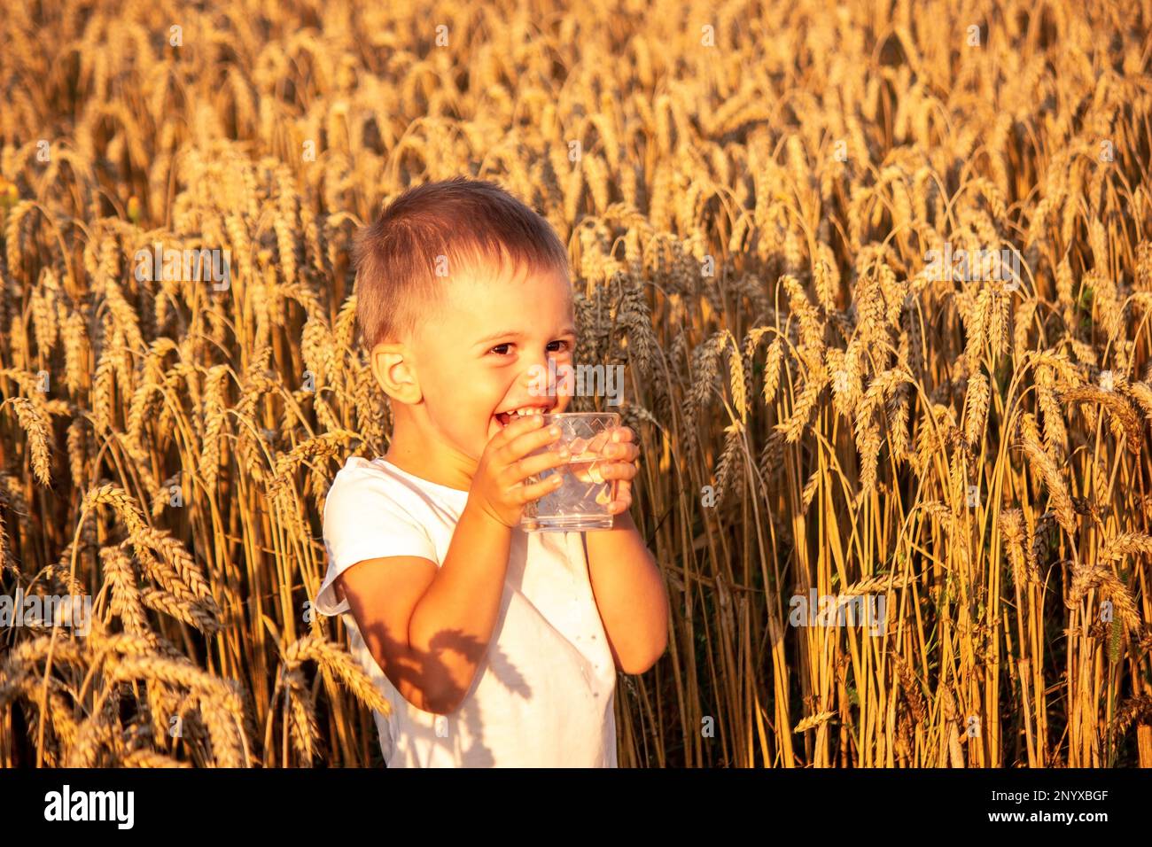 The child drinks water from a glass. Selective focus. Kid Stock Photo - Alamy