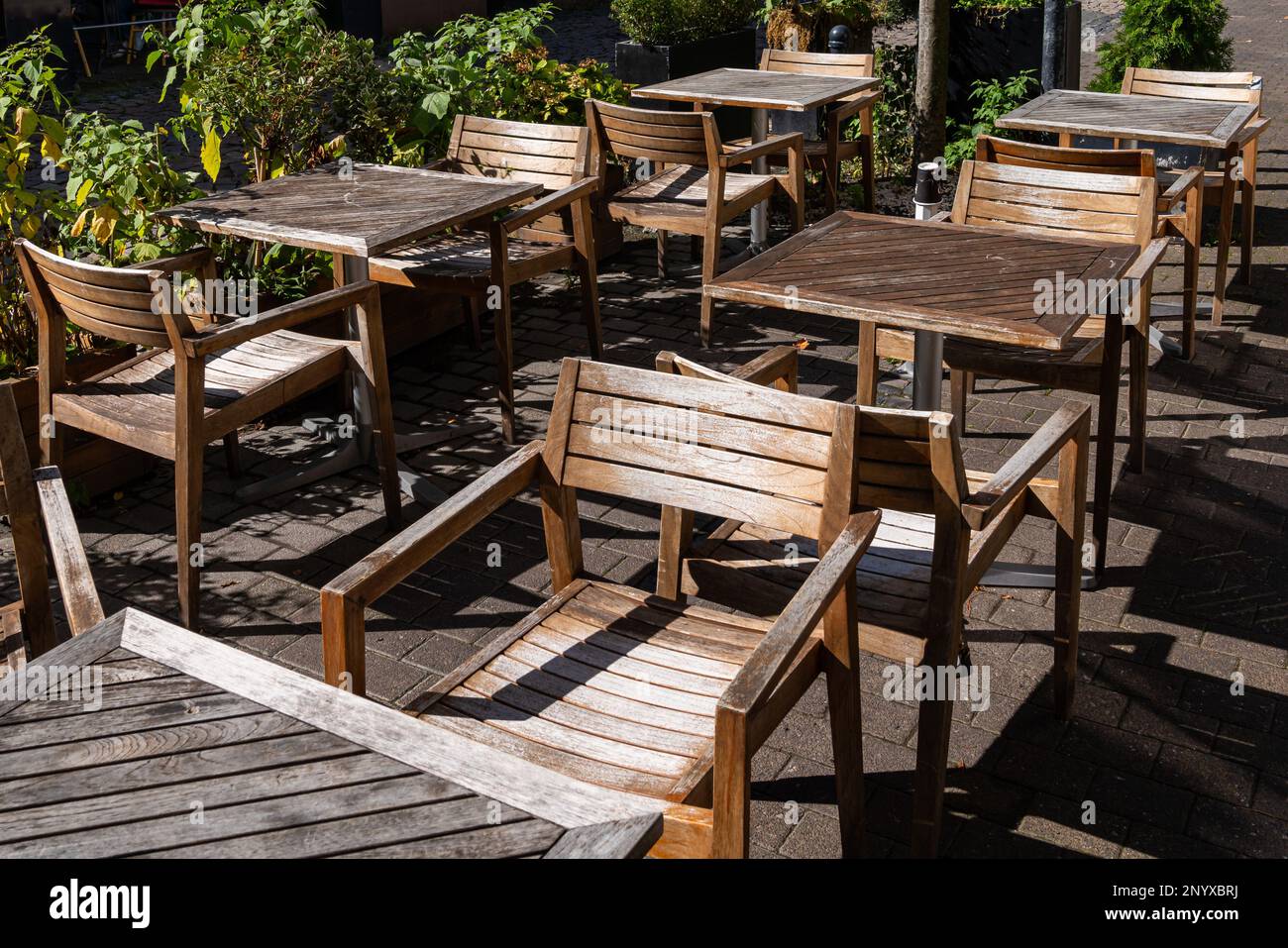 Empty wooden brown tables and chairs in a street cafe Stock Photo - Alamy