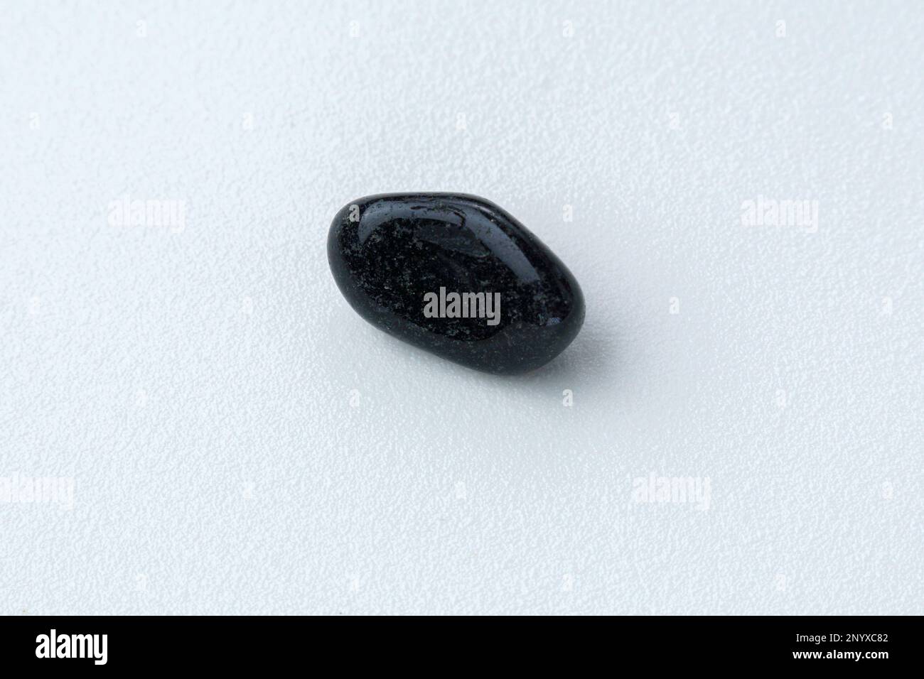 Natural mineral rock specimen polished black Onyx gemstone on white ...