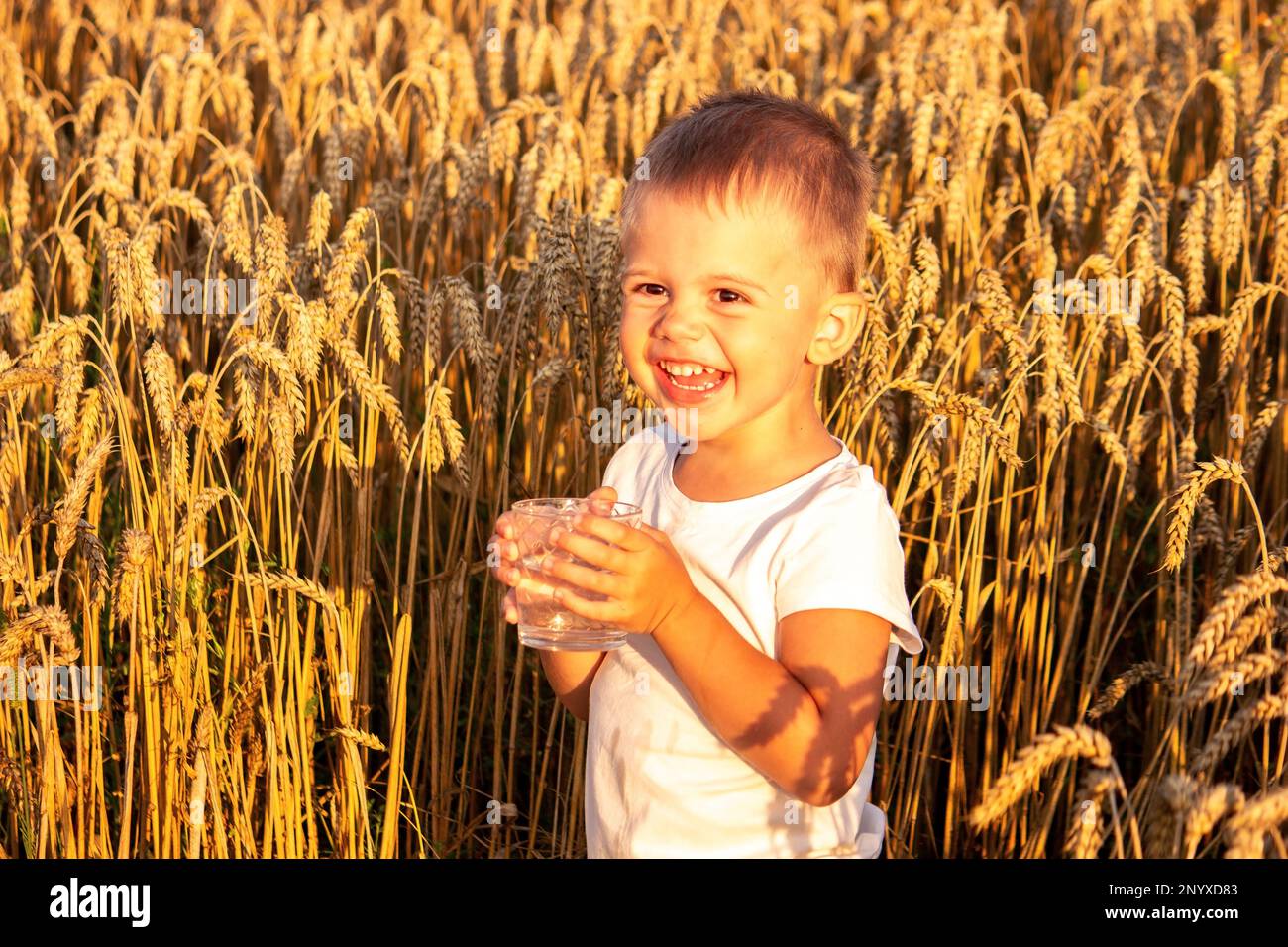 The child drinks water from a glass. Selective focus. Kid Stock Photo - Alamy