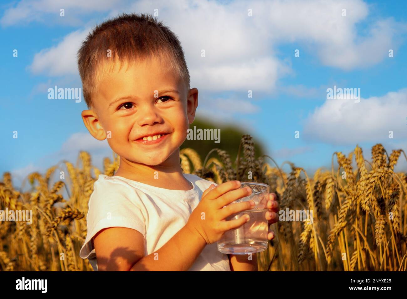 The child drinks water from a glass. Selective focus. Kid Stock Photo - Alamy