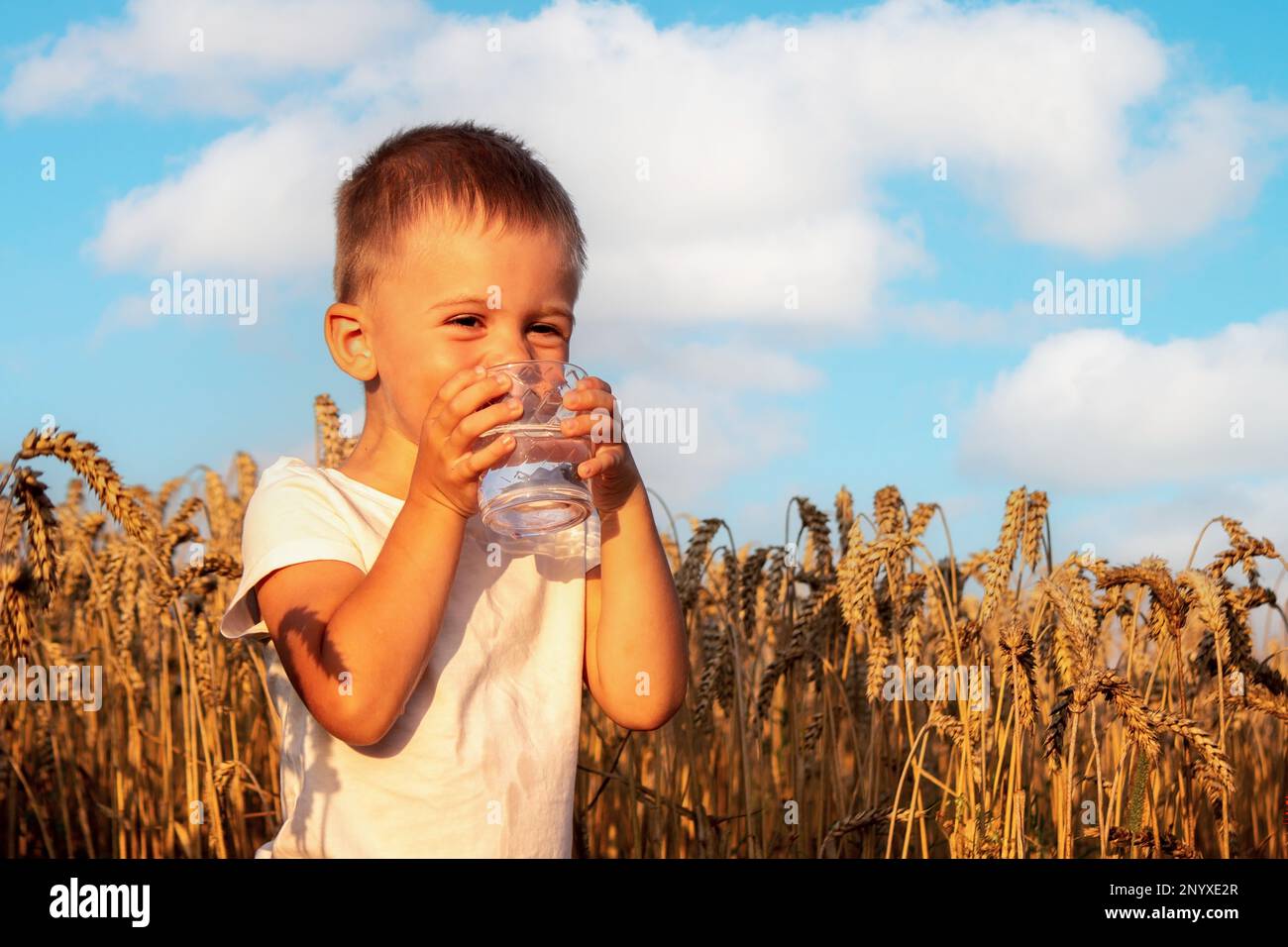The child drinks water from a glass. Selective focus. Kid Stock Photo - Alamy