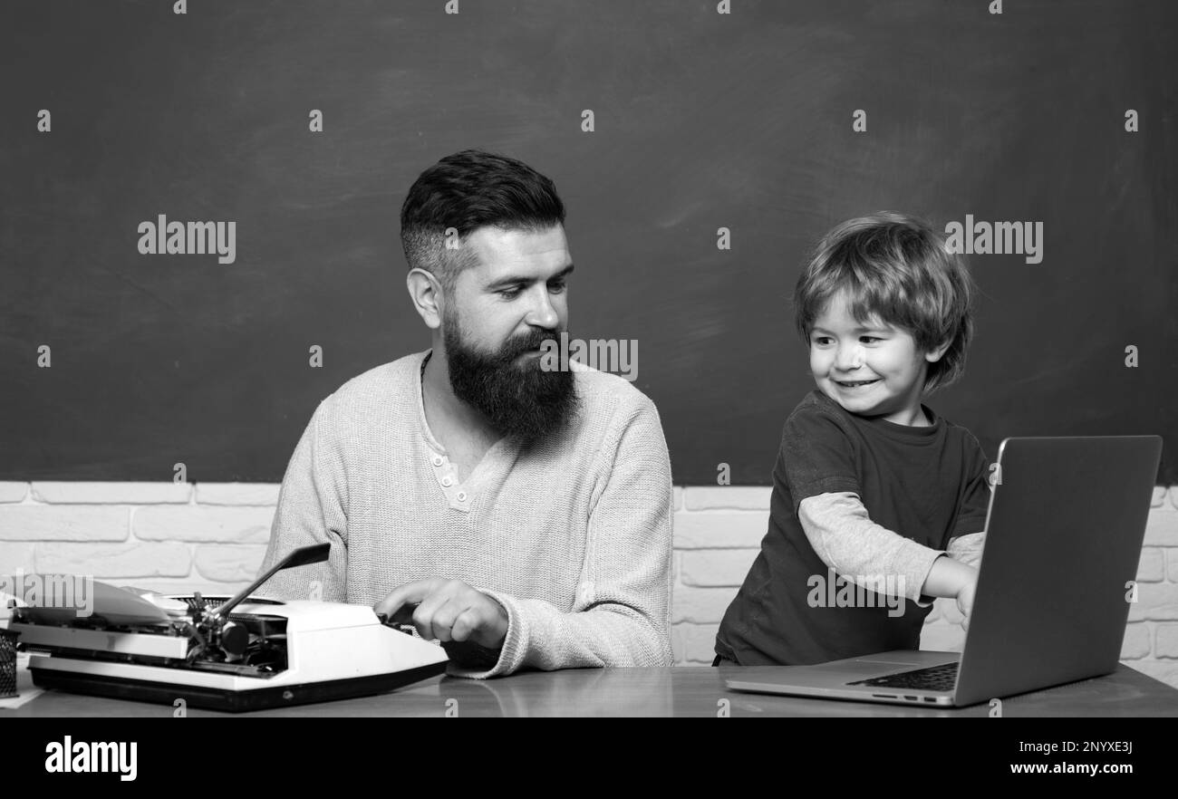 Teacher helping young boy with lesson. First day in school. Teacher ...