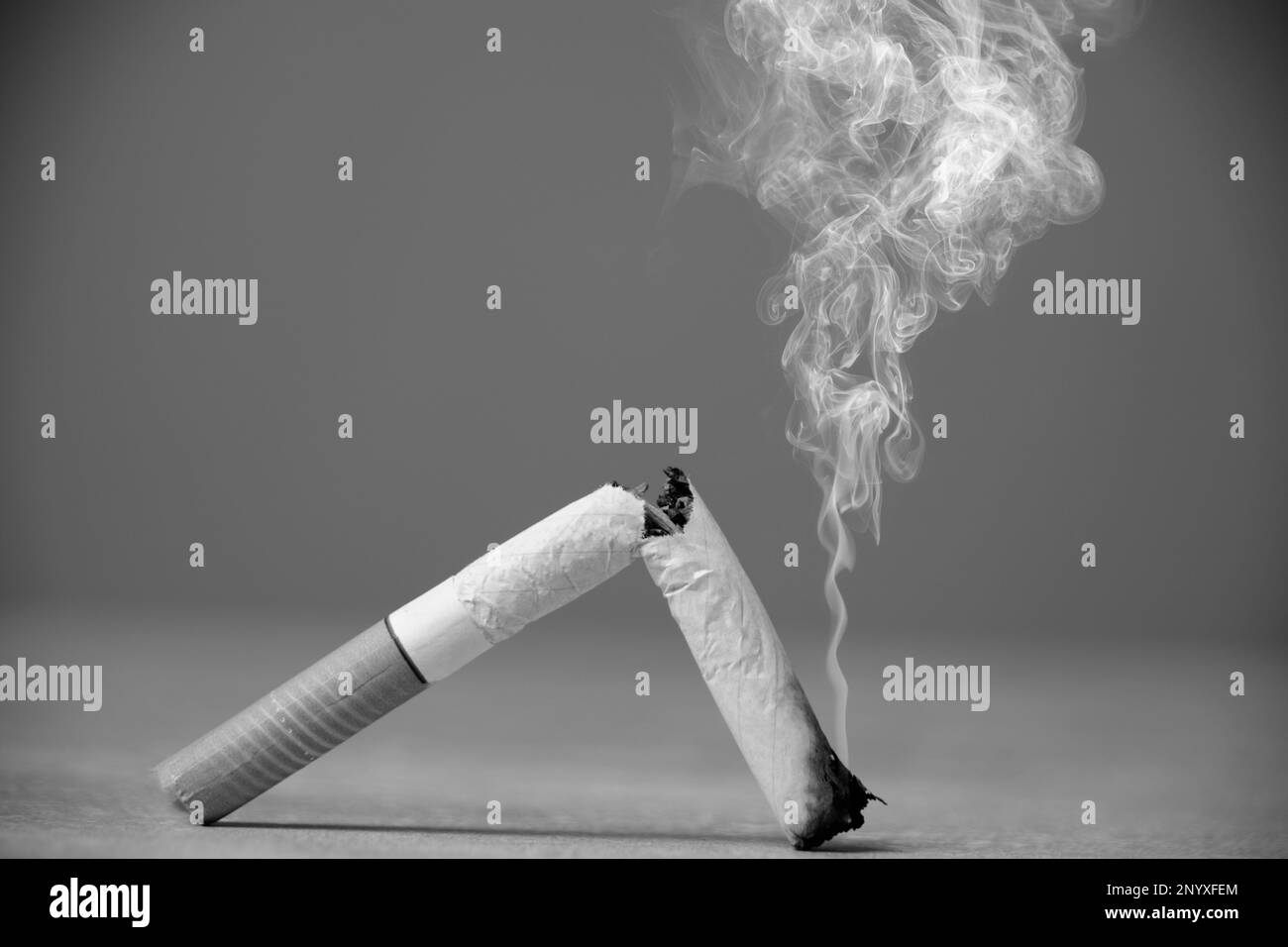 Broken smoking cigarette in black and white photo Stock Photo - Alamy