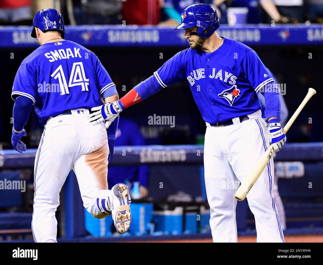 Toronto Blue Jays' Justin Smoak (14) is congratulated by Steve Pearce ...