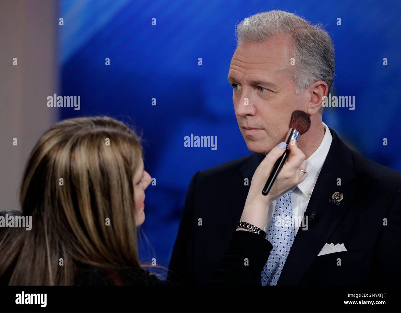 New Jersey Assemblyman John Wisniewski, right, is touched up by a ...