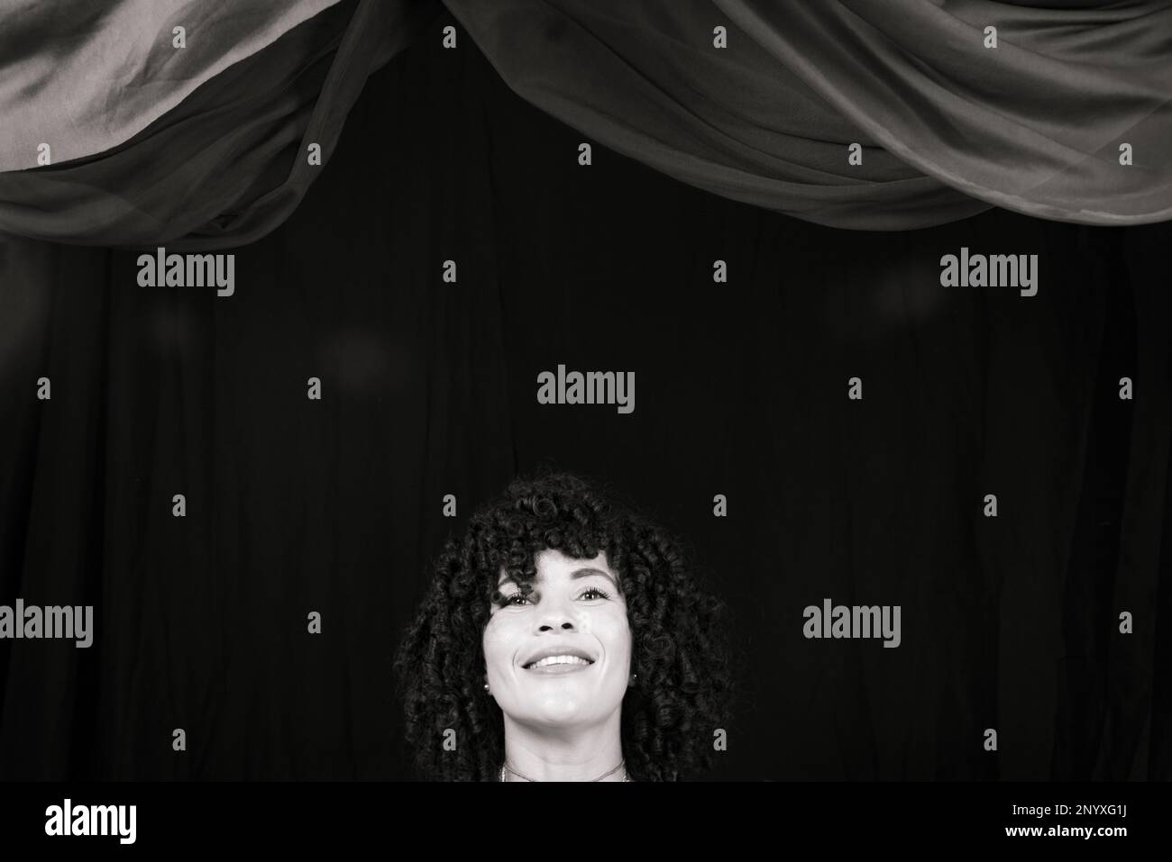 Black and white portrait of woman throwing cloth in the air. Isolated ...
