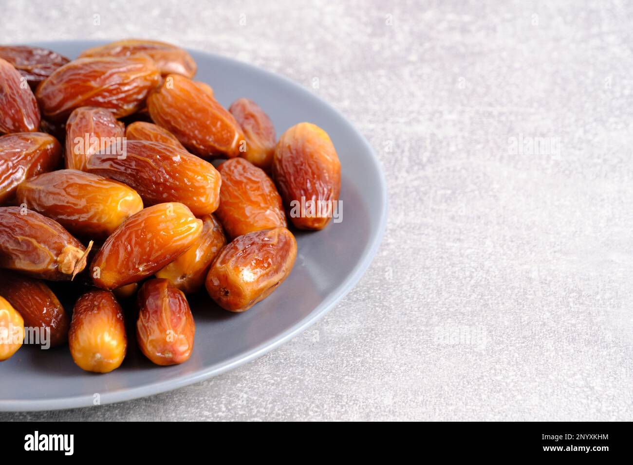 Dates plate gray background.Edible fruits date palm Stock Photo - Alamy