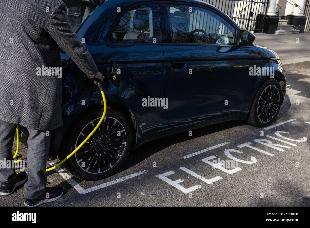 Electric FIAT 500 charging on a street charging bay in central London ...