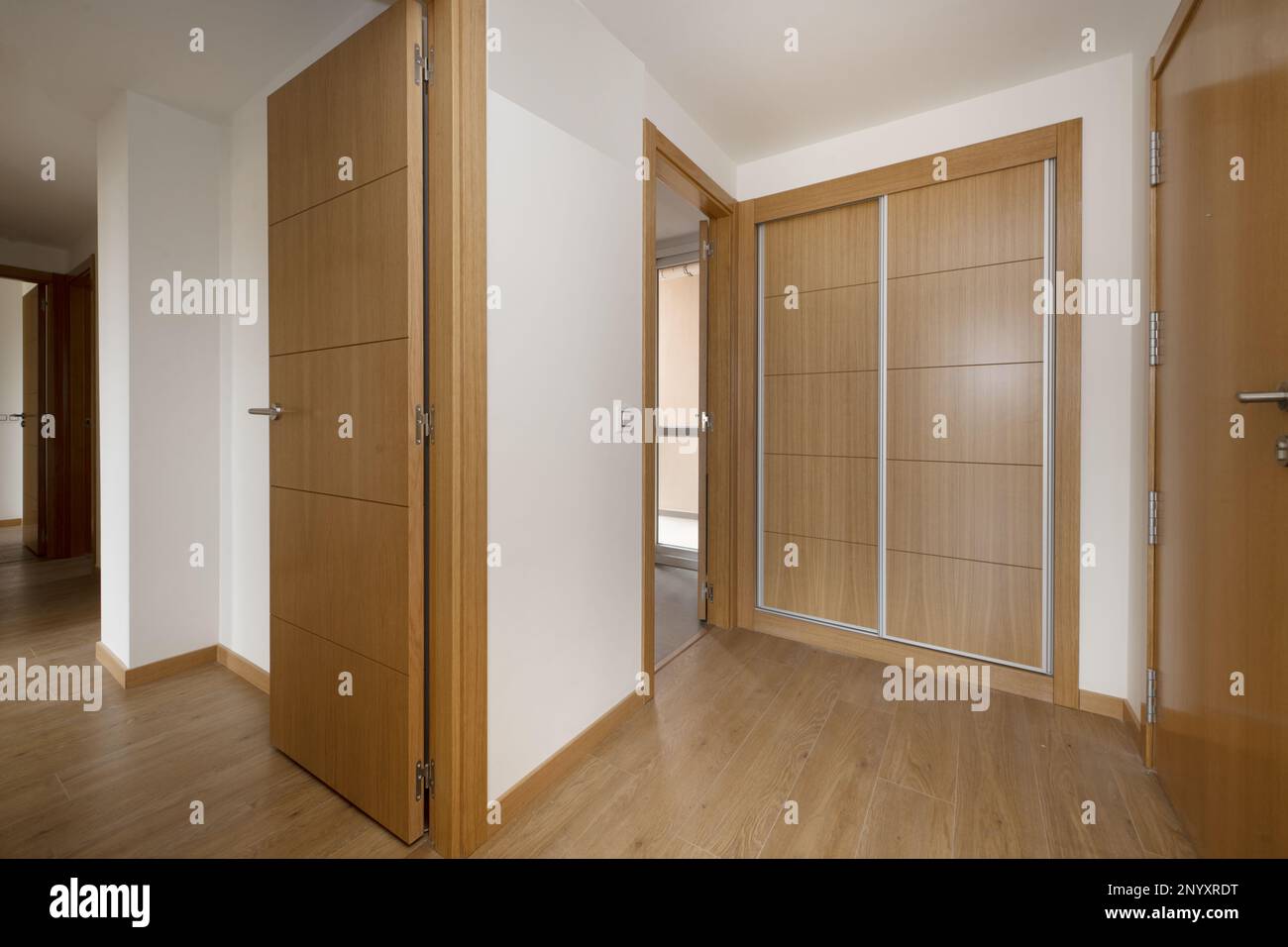 Entrance hall of an empty house with an oak access door to match the ...